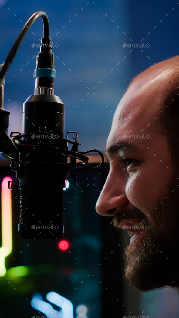 Pro streamer sitting on gaming chair talking with players using ...