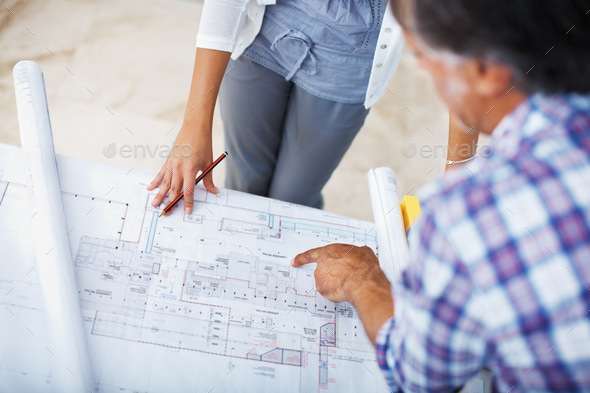 Architect showing plan to female client. Closeup of architect showing ...