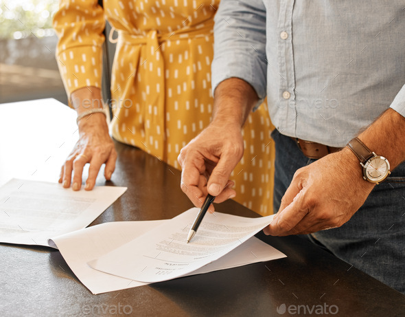 Theres a lot of paperwork. Shot of two unrecognizable people going ...