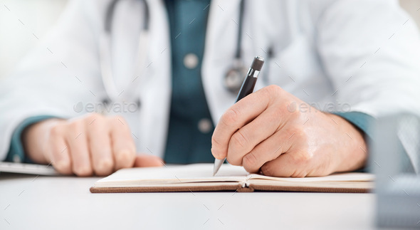 Closeup shot of an unrecognisable doctor writing notes in a medical ...