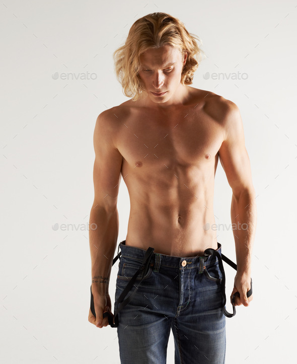 Hes in good shape. Studio shot of a handsome young shirtless man. Stock ...