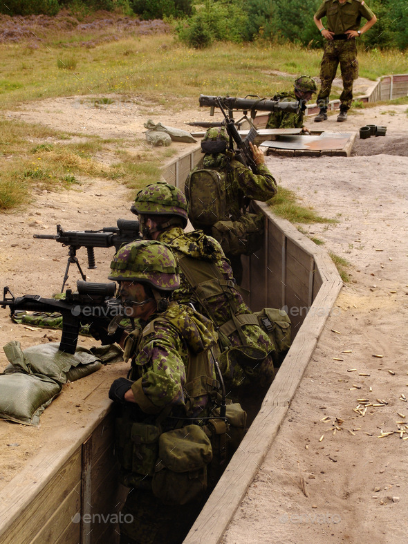 Trench warfare. Soldiers standing in a trench and aiming their rifles ...