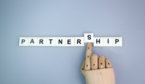wooden hand and alphabet letters with the word partnership Stock Photo ...