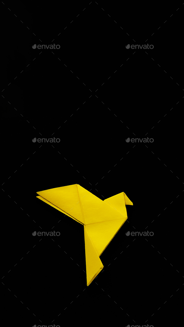 yellow paper origami pigeon on black background, minimalism, vertical ...