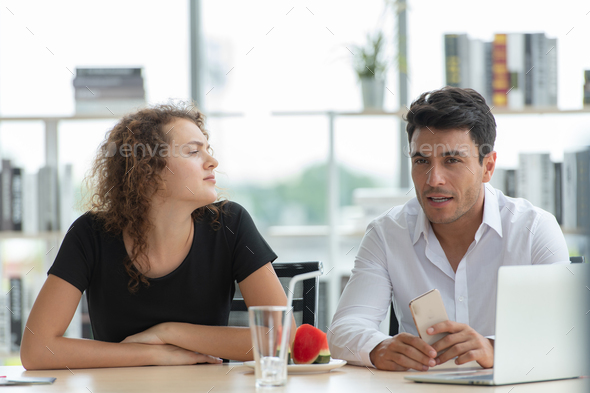 Two office workers searching for tourist attractions, booking tickets ...