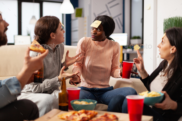 Multiethnic group of people play guessing game with sticky notes Stock ...