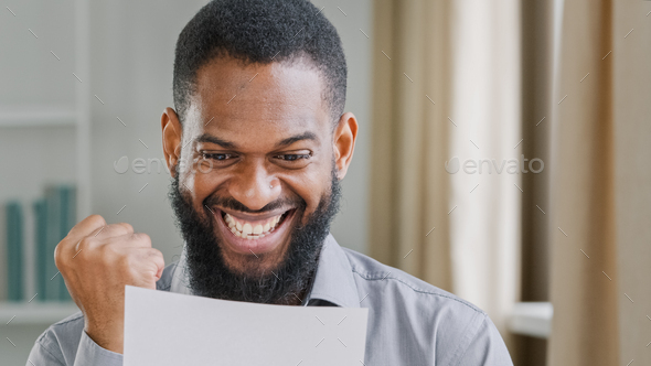 Success ethnic winner man excited male executive reading mail salary ...