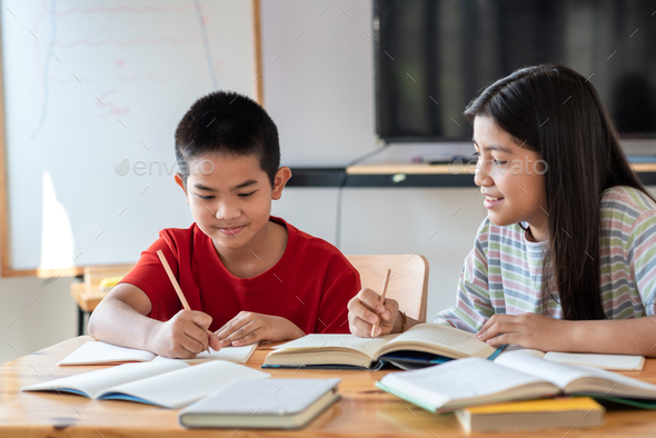 Asian boy and girl student are studying together in the classroom ...