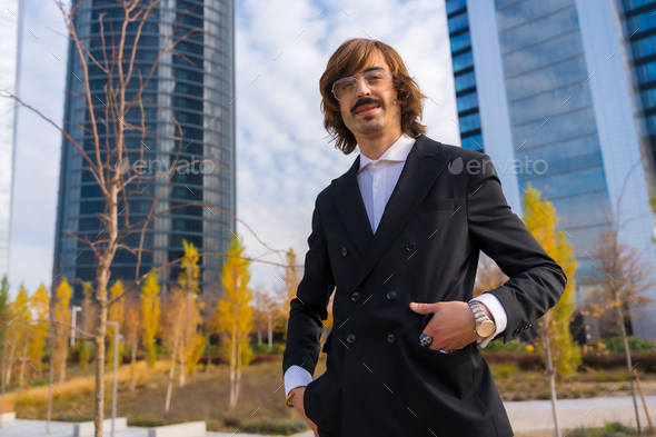 Corporate portrait of alternative businessman, business park, smiling ...