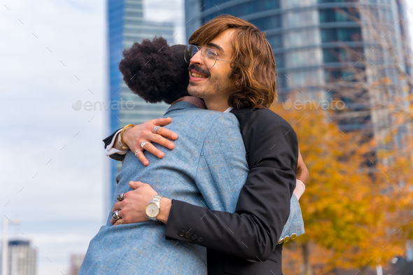 Multi-ethnic businessmen and businesswomen, hugging each other, good ...