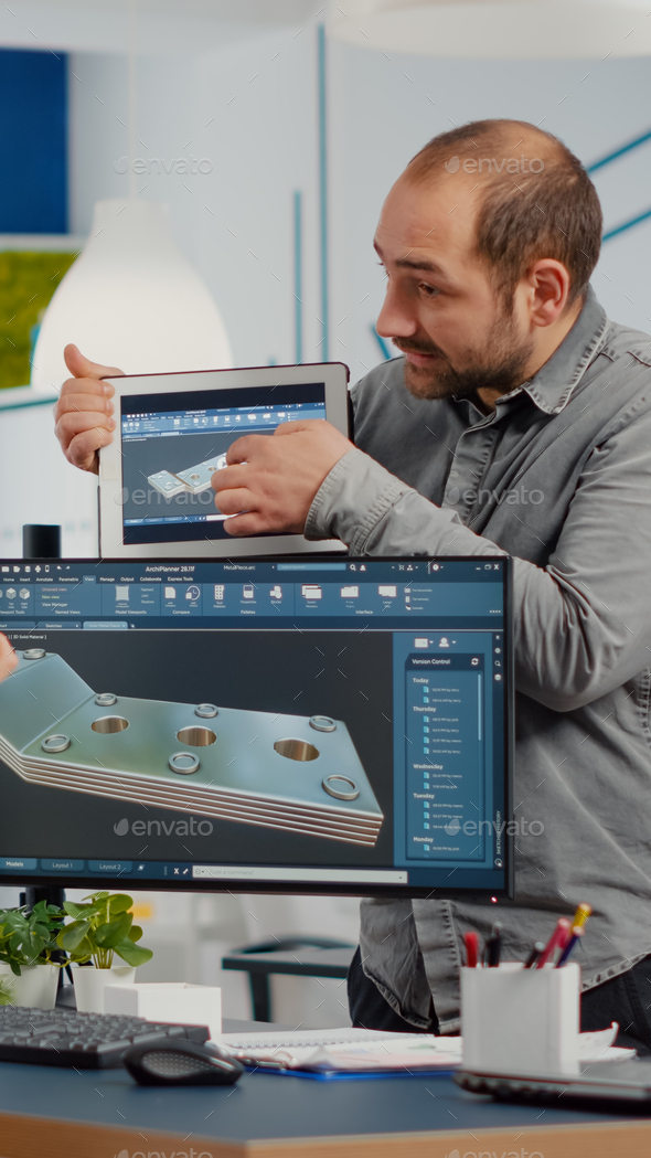 Team of architects and engineers working on building prototype project ...