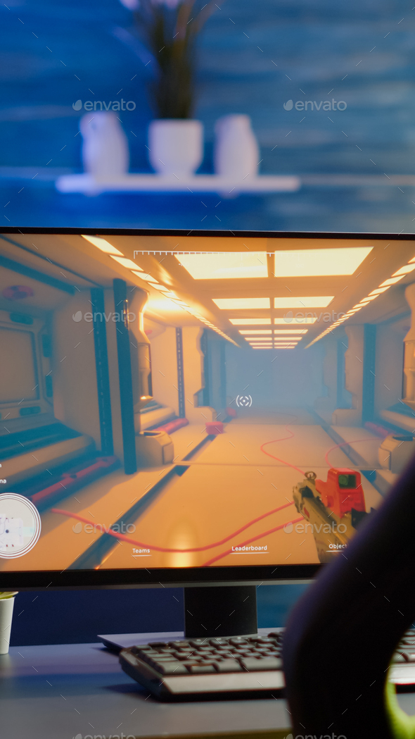 RGB powerful computer gamer rig with FPS videogame on screen Stock ...