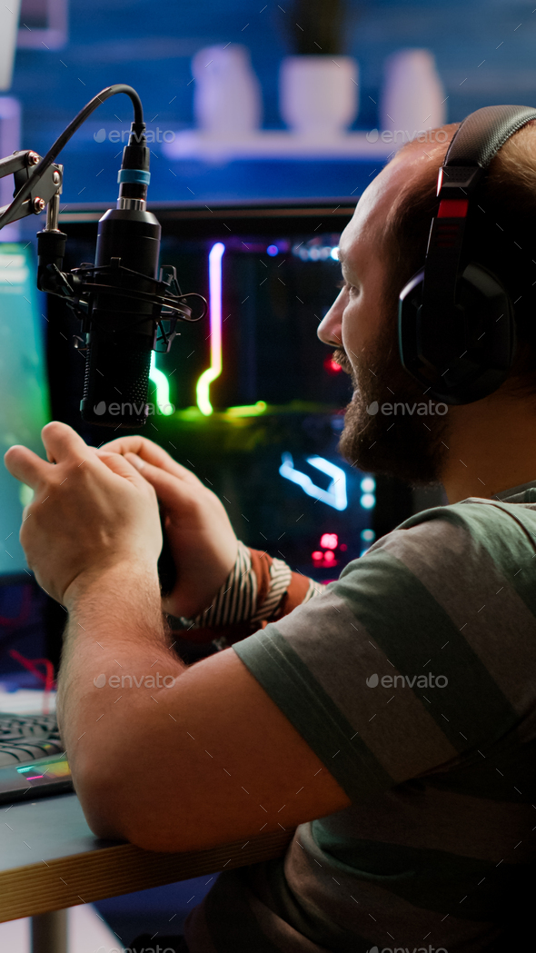 Concentrated gamer playing shooter game in gaming competition Stock ...