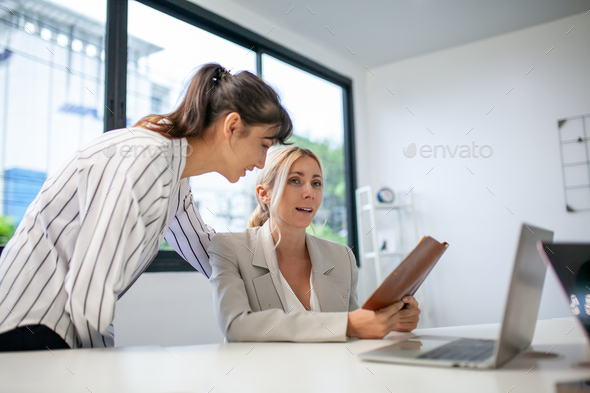 business team female colleagues talking at work share ideas with laptop ...