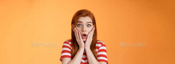 Close-up shocked speechless redhead woman, drop jaw gasping, touch ...