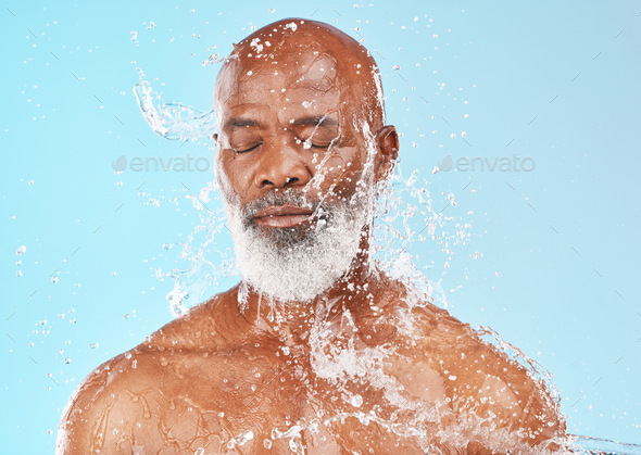 Senior black man, water splash and skincare in studio for wellness, clean or health facial by ...