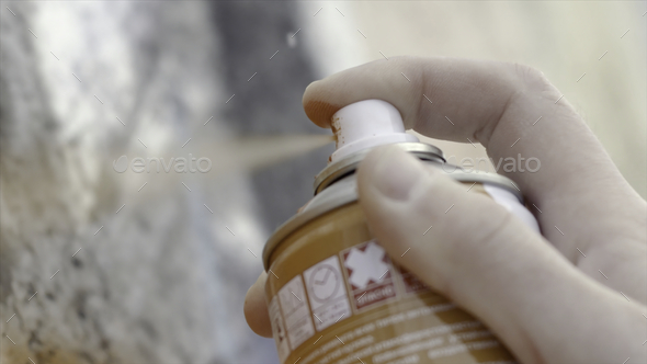 Close-up of artist draws street art spraying spray paint. Action ...