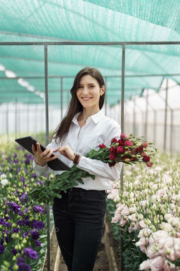 Fresh flowers delivery, women taking order on the tablet. Stock Photo ...