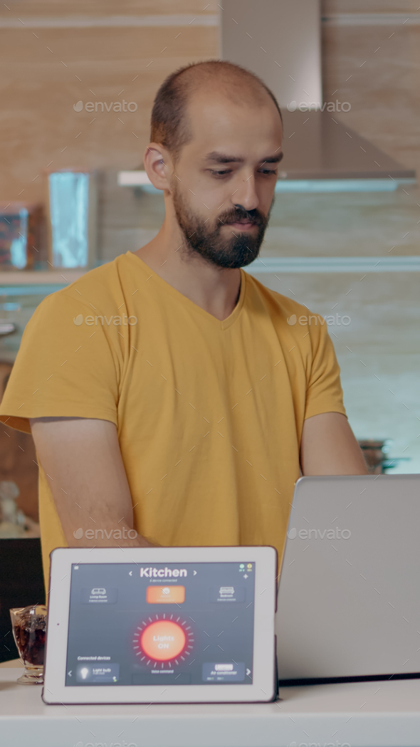 Remote person working in modern house giving voice command to tablet ...