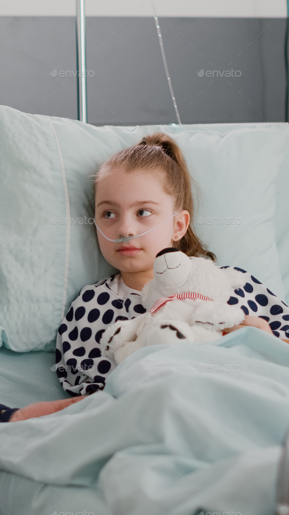 Father sitting beside sick daughter discussing sickness therapy ...