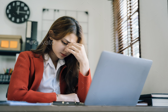 Tired asian businesswoman with headache at office, feeling sick at work ...