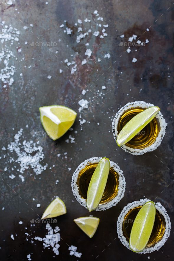 Golden mexican tequila shot with green lime and salt Stock Photo by ...