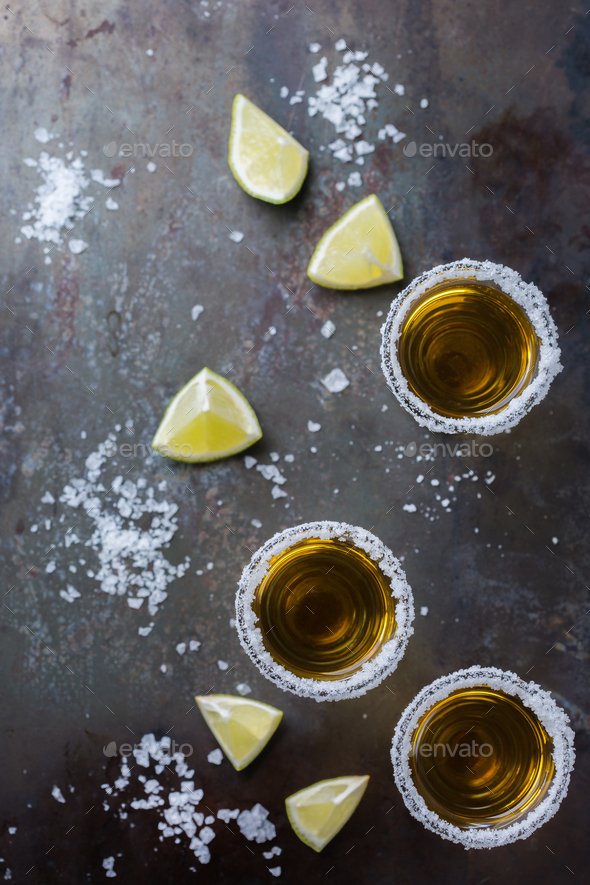 Golden mexican tequila shot with green lime and salt Stock Photo by ...