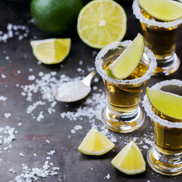 Golden mexican tequila shot with green lime and salt Stock Photo by ...
