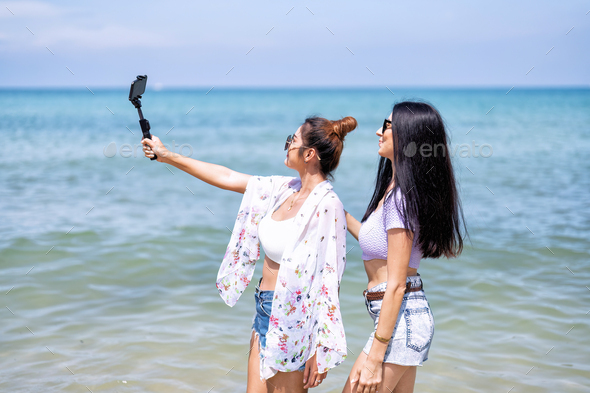 Couple LGBTQ girl on holiday happy running playing dancing along the ...