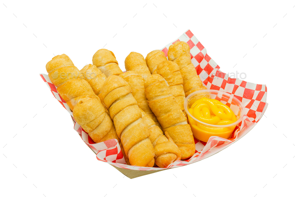 Venezuelan tequeños portion stacked in small basket with yellow sauce ...