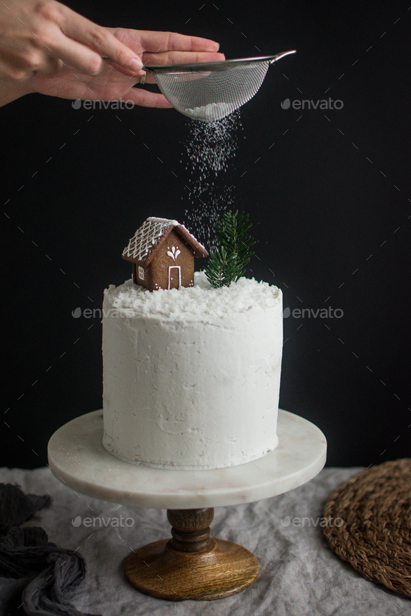 Cake with gingerbread house powdered sugar Stock Photo by wirestock