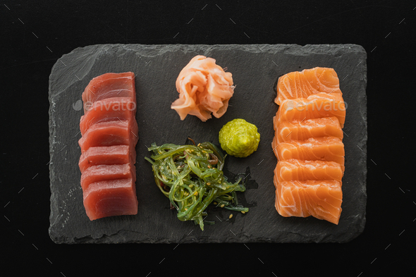 Top view of assorted Japanese sashimi on a board Stock Photo by wirestock