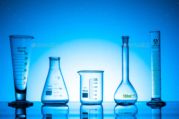 Variety of glass flasks and lab equipment on a blue background Stock ...