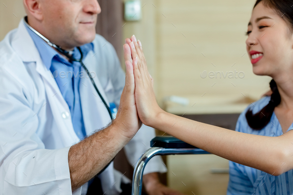 Doctor encouraged doctor give high five patient and encouragement is ...