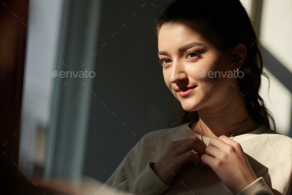 Woman Putting on Pedant Stock Photo by DragonImages | PhotoDune