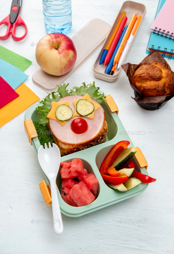 School lunch box for kids with food in the form of funny faces. School ...