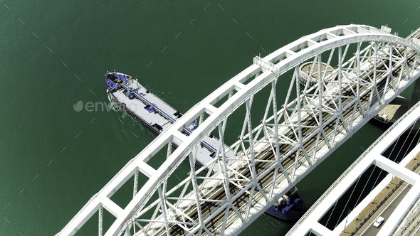 Top view of boat passing under bridge. Action. Long cargo boat sails ...