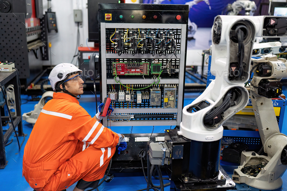 Engineer hold multimeter testing cable wiring robotic control panel at ...