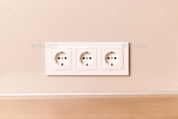 Electrical outlets on beige wall Stock Photo by Bykfa | PhotoDune