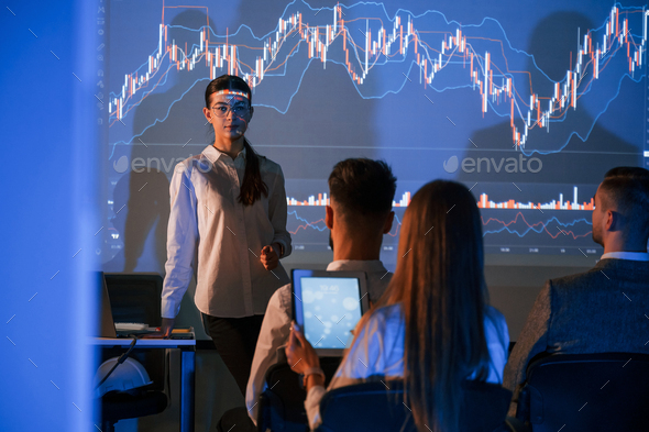Showing the plan on the projector. Female leader talking to employees ...