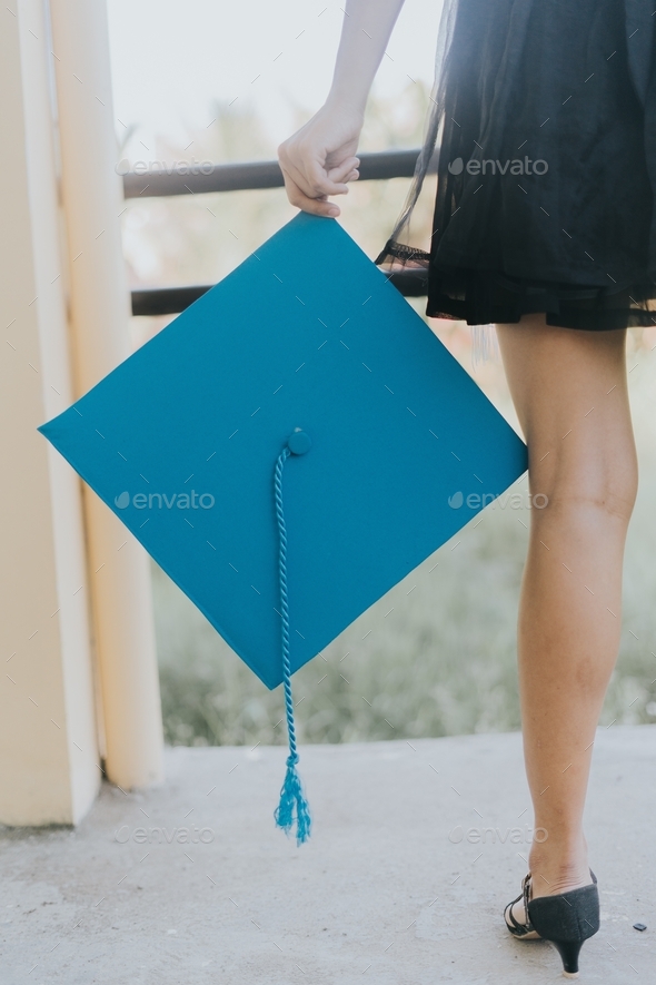 Potrait of a Filipino Woman Holding her Graduation Cap and Gown Stock ...