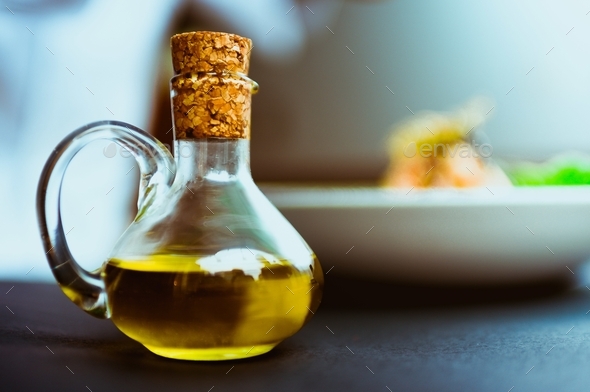 Bottle of cooking oil on a kitchen table Stock Photo by wirestock ...