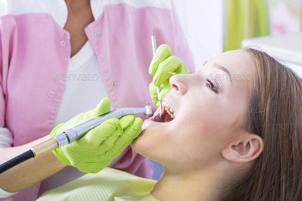 Young girl having teeth examination at dental clinic Stock Photo by ...