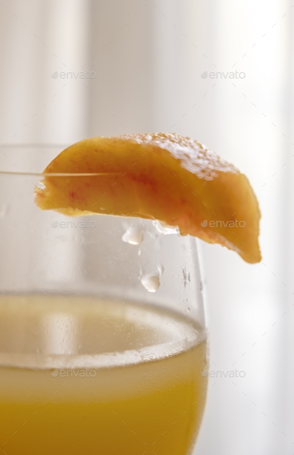 Closeup vertical shot of freshly squeezed orange juice in a tall glass ...