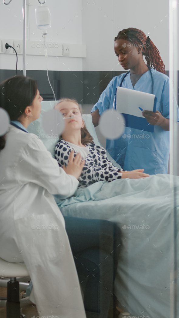 Pediatric doctor examining breathing sickness symptoms while african ...