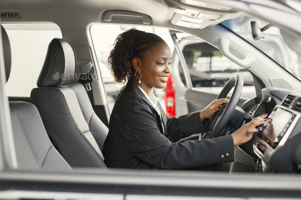 Portrait of black female driver in a car wearing black costume Stock ...