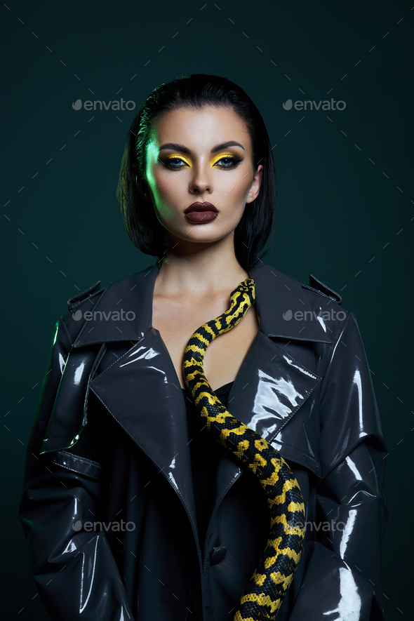 Beauty woman python yellow snake around her neck on latex shiny ...
