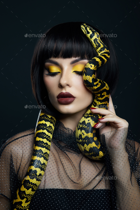Beauty woman short haircut python yellow snake on her neck. A yellow ...