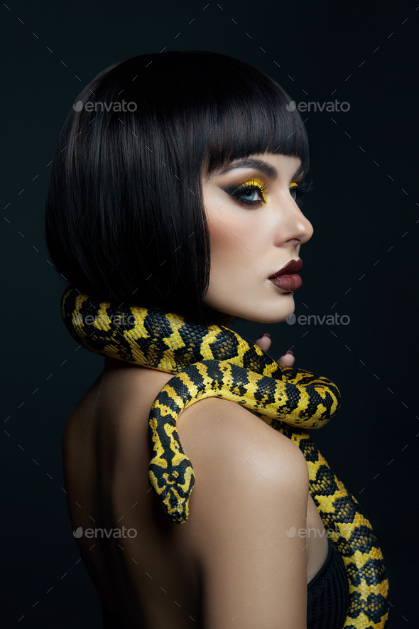 Beauty woman short haircut python yellow snake on her neck. A yellow ...