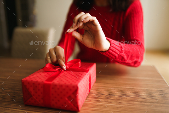 Female hands opening red gift box. Unpacking a gift. Valentines day ...